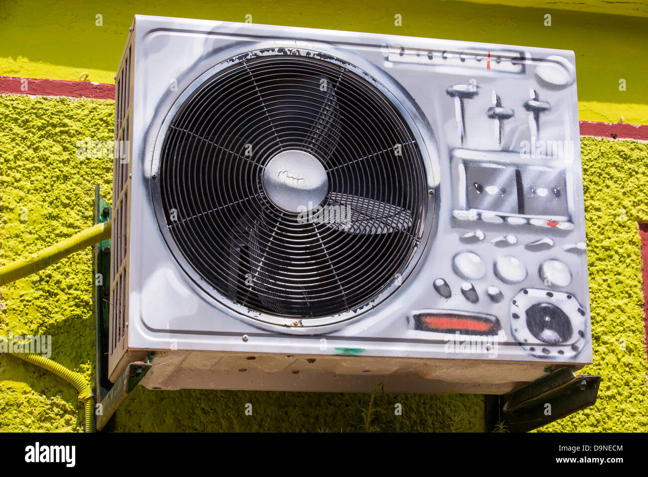 A air conditioning unit painted to look like a radio on a cafe wall in ...