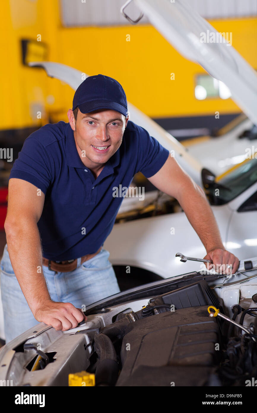 happy auto mechanic at work inside garage Stock Photo - Alamy