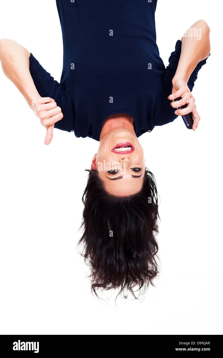 upside down view of young woman holding smart phone and giving thumb up ...