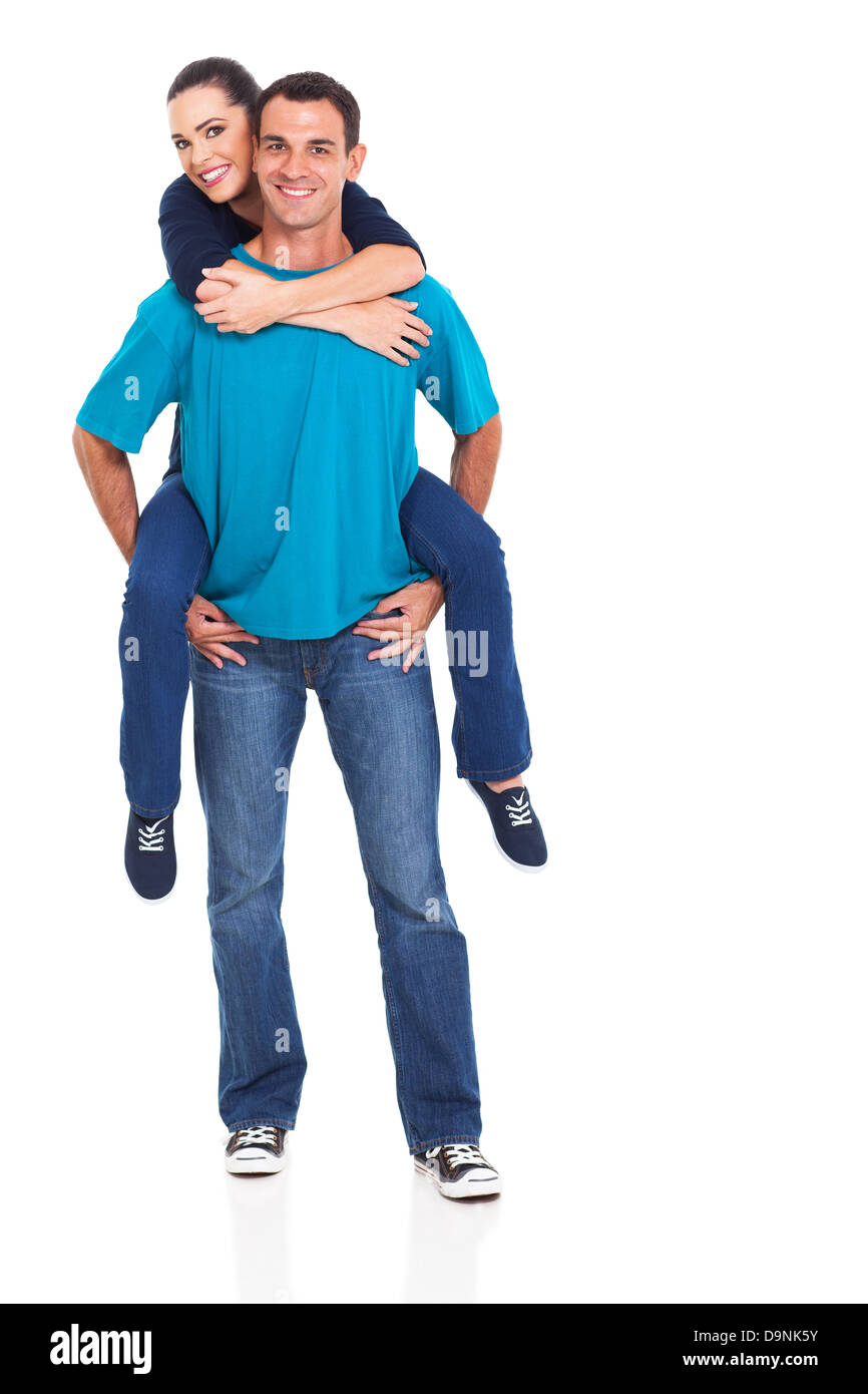 portrait of cheerful young couple piggyback over white background Stock ...