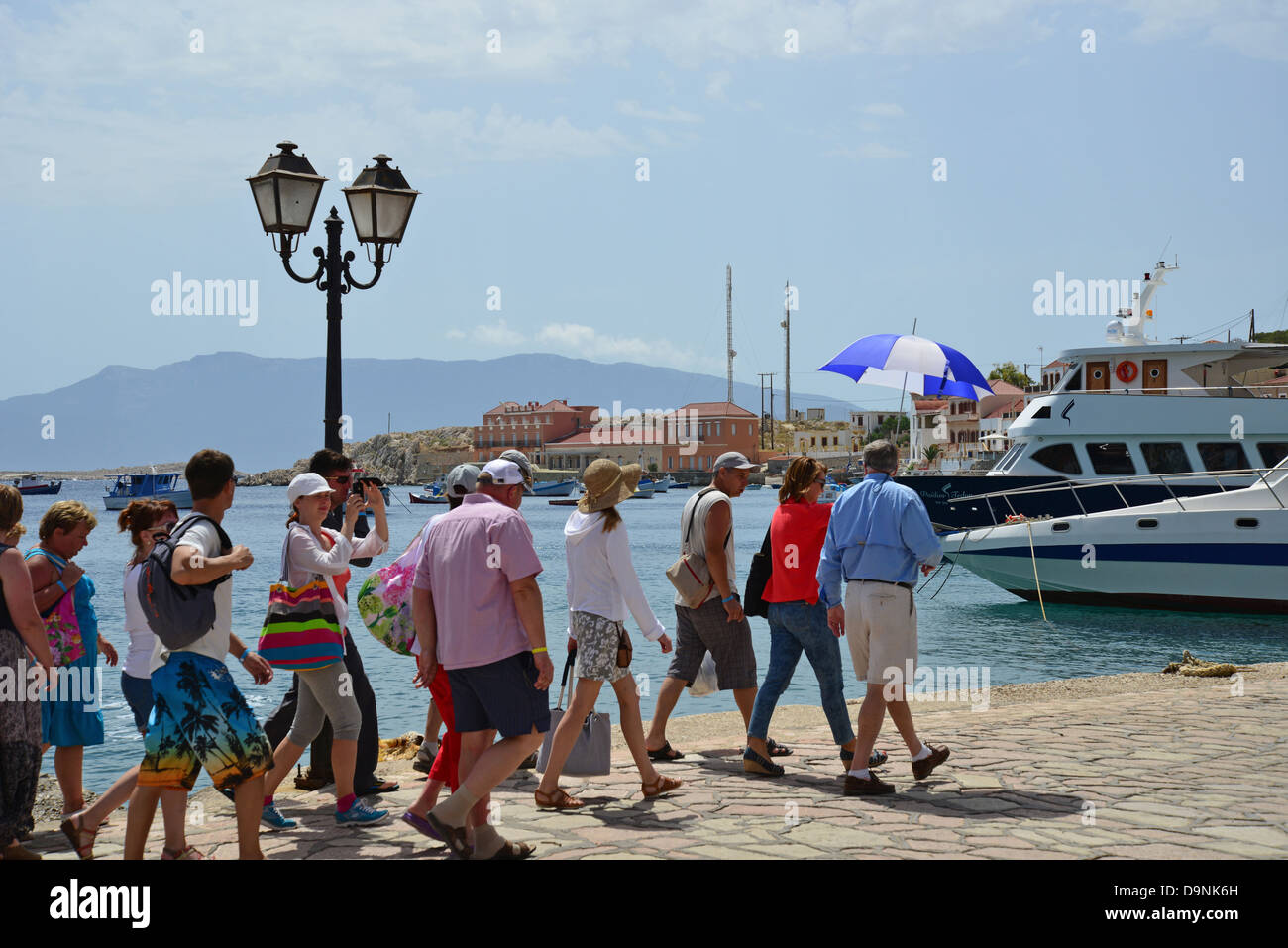 Tour group on waterfront, Port of Emporio, Halki (Chalki), Rhodes ...