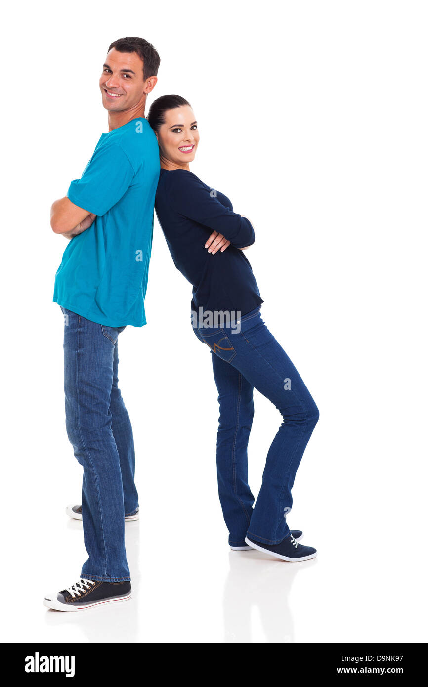happy young couple standing back to back on white background Stock ...