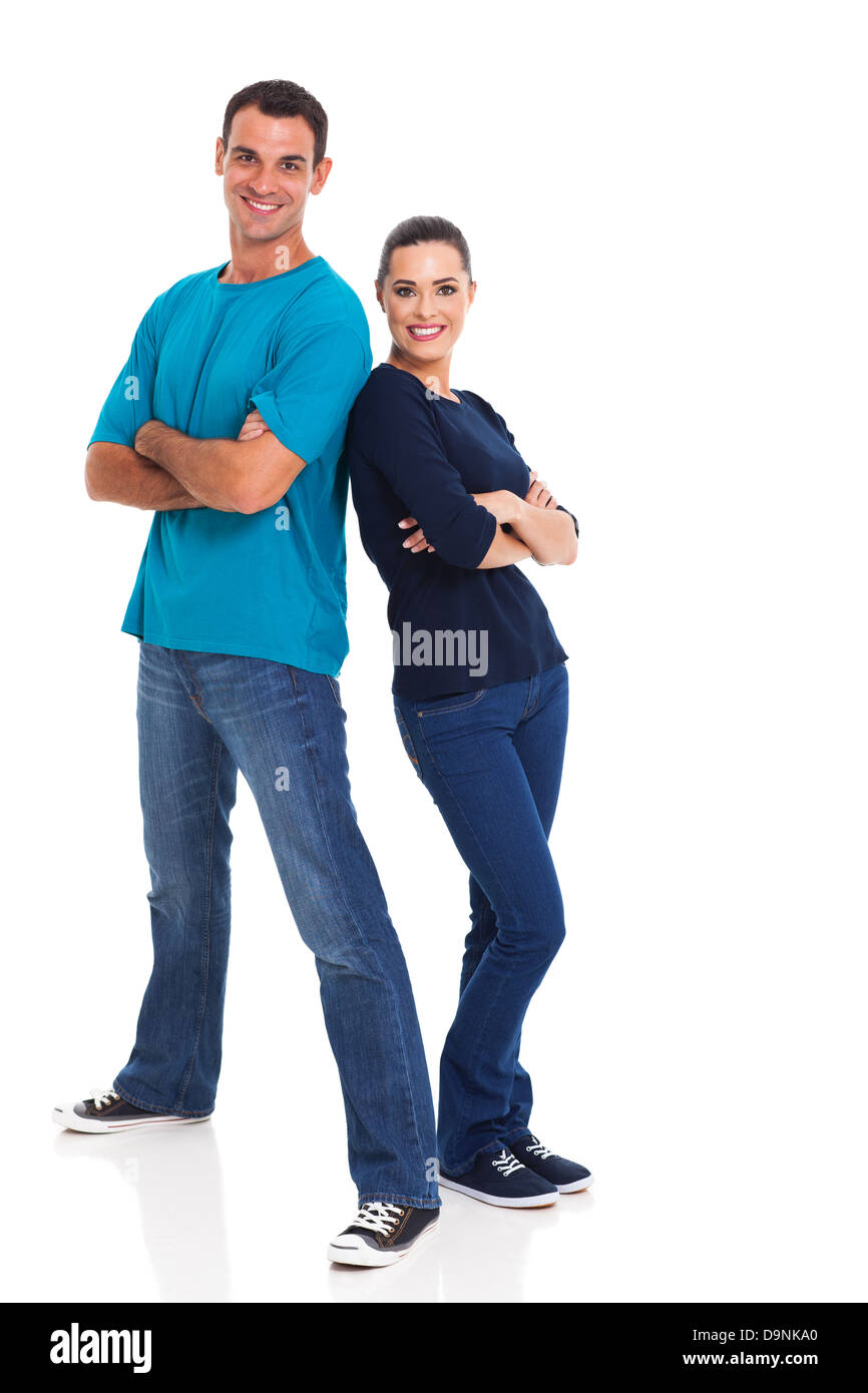 portrait of cheerful young couple leaning on each other over white ...