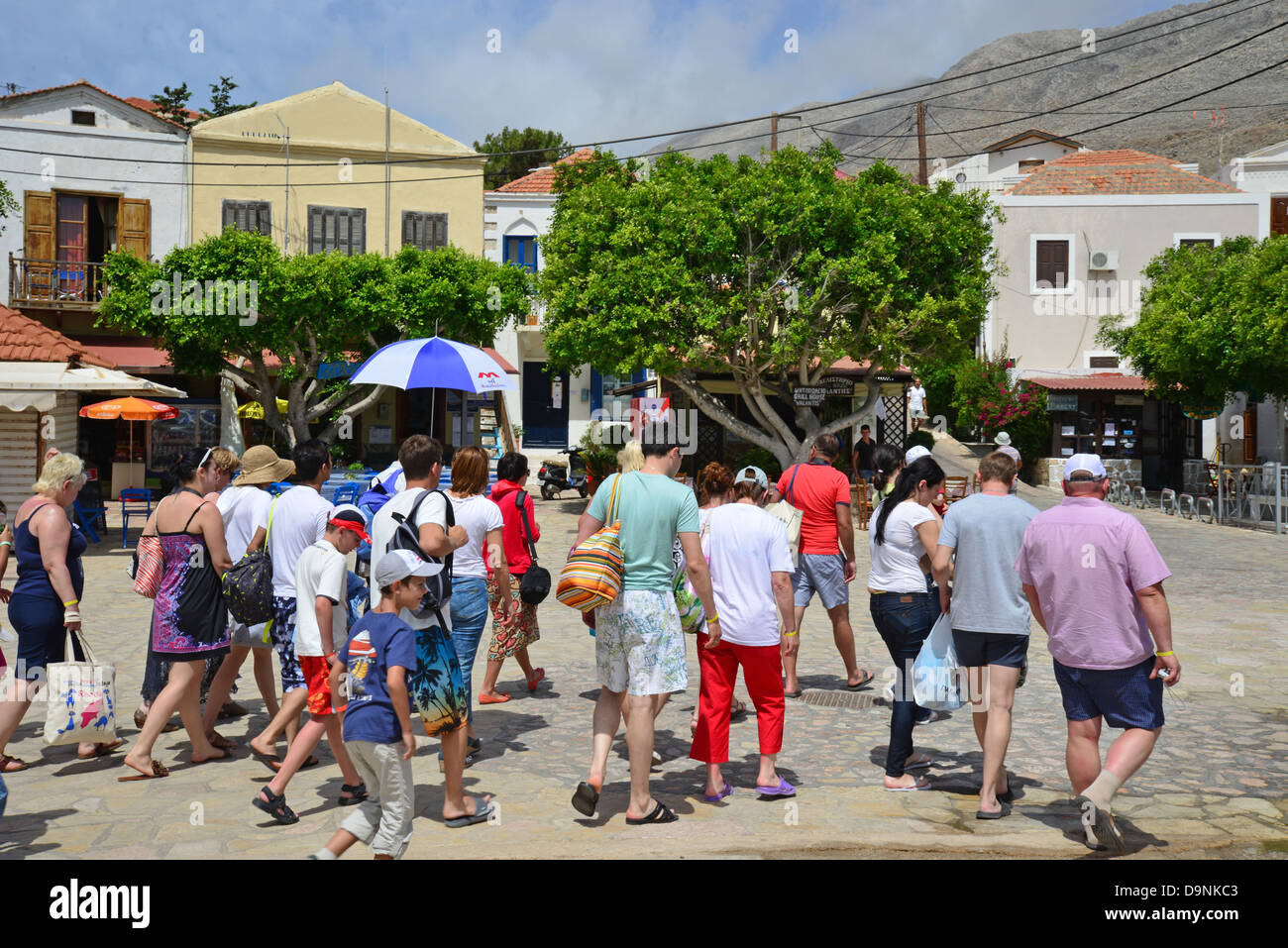 Tour group on waterfront, Port of Emporio, Halki (Chalki), Rhodes ...