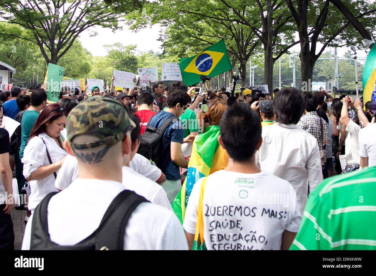 Tokyo, Japan. June 23, 2013. A hundred of Brazilians hold placards and ...
