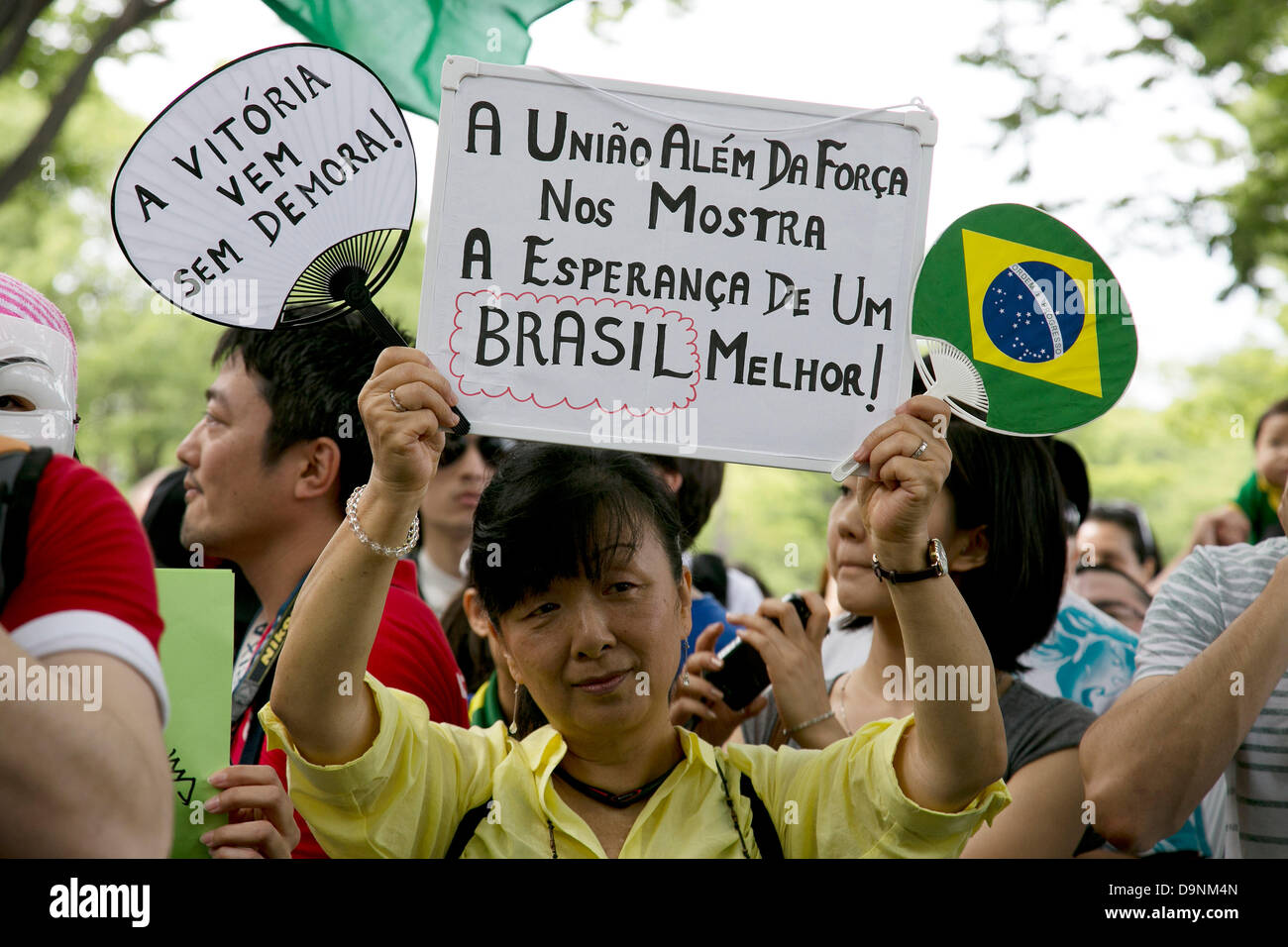 Tokyo, Japan. June 23, 2013. A hundred of Brazilians hold placards and ...
