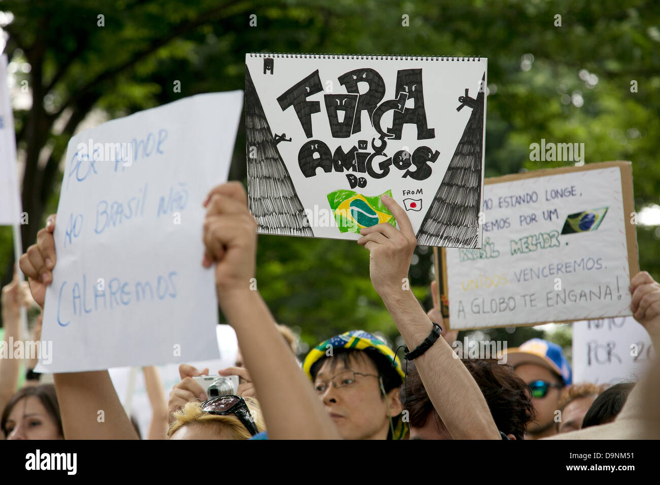 Tokyo, Japan. June 23, 2013. A hundred of Brazilians hold placards and ...
