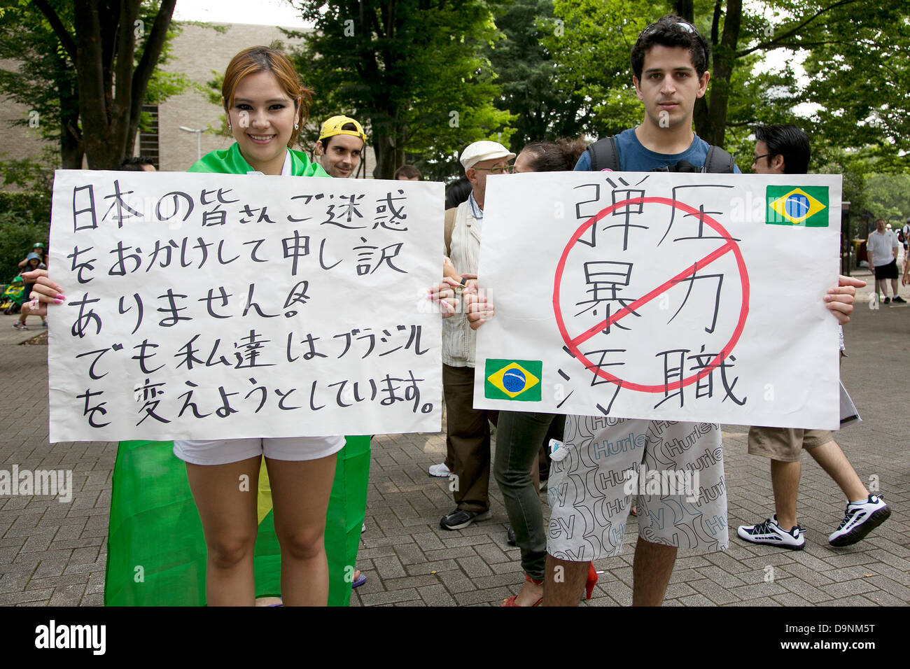 Tokyo, Japan. June 23, 2013. A hundred of Brazilians hold placards and ...