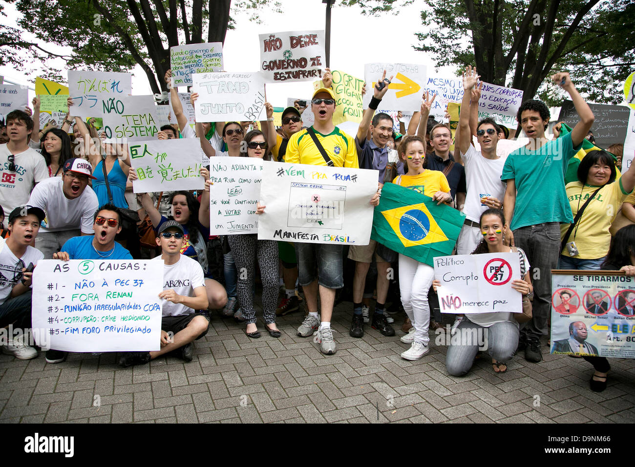 Tokyo, Japan. June 23, 2013. A hundred of Brazilians hold placards and ...