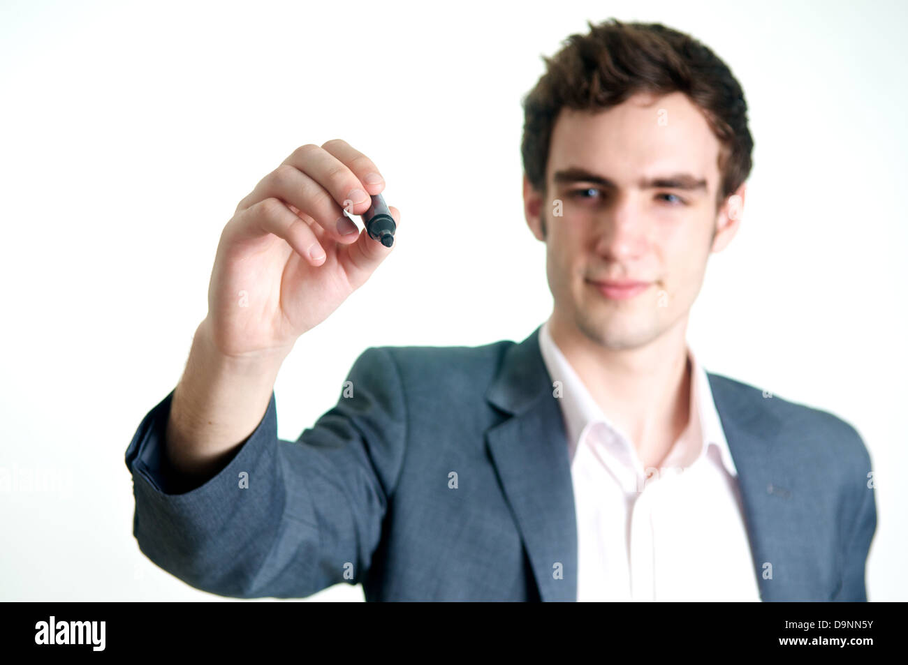 Professional young man writing with marker Stock Photo - Alamy