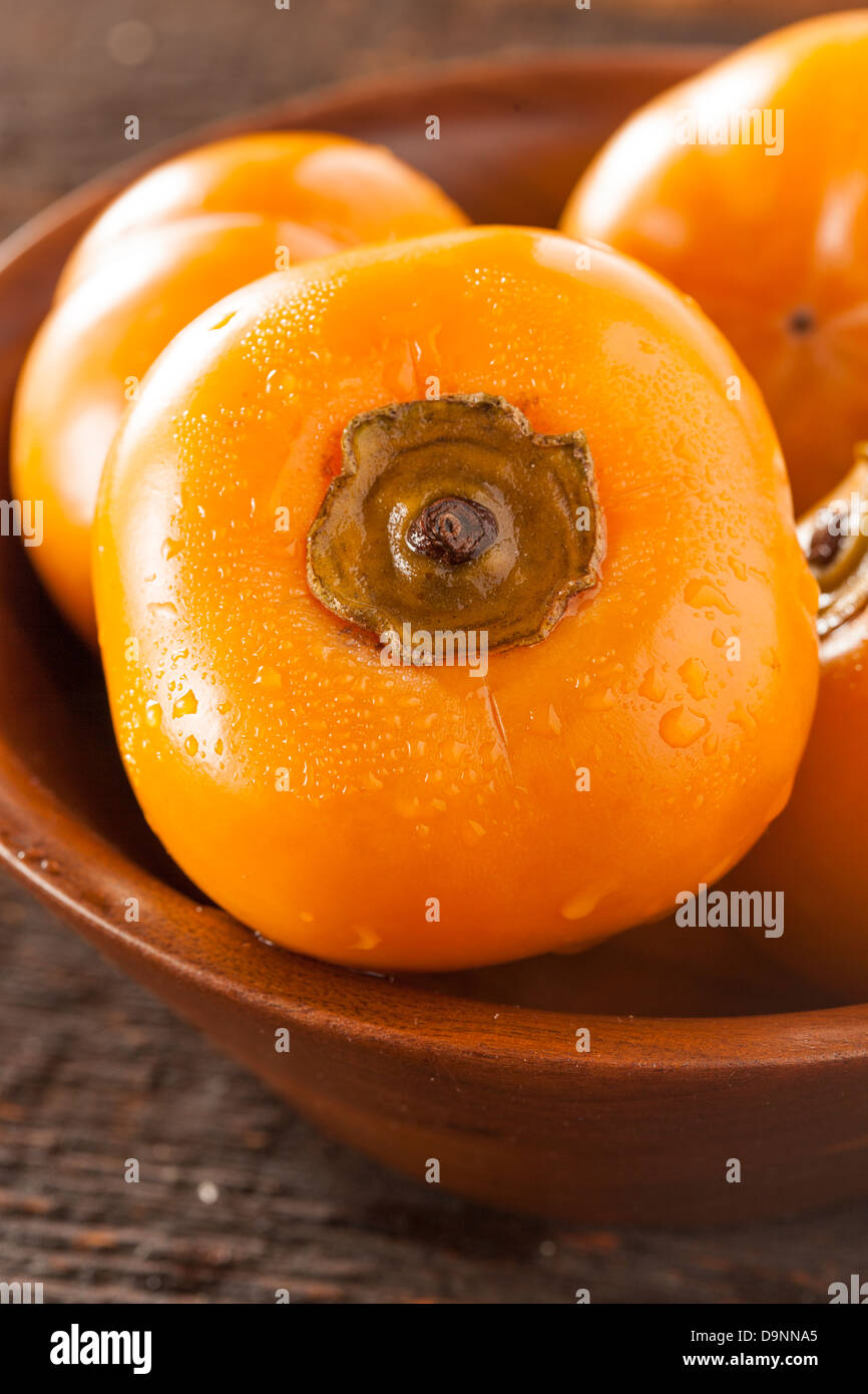 Organic Orange Persimmon Fruit against a background Stock Photo - Alamy