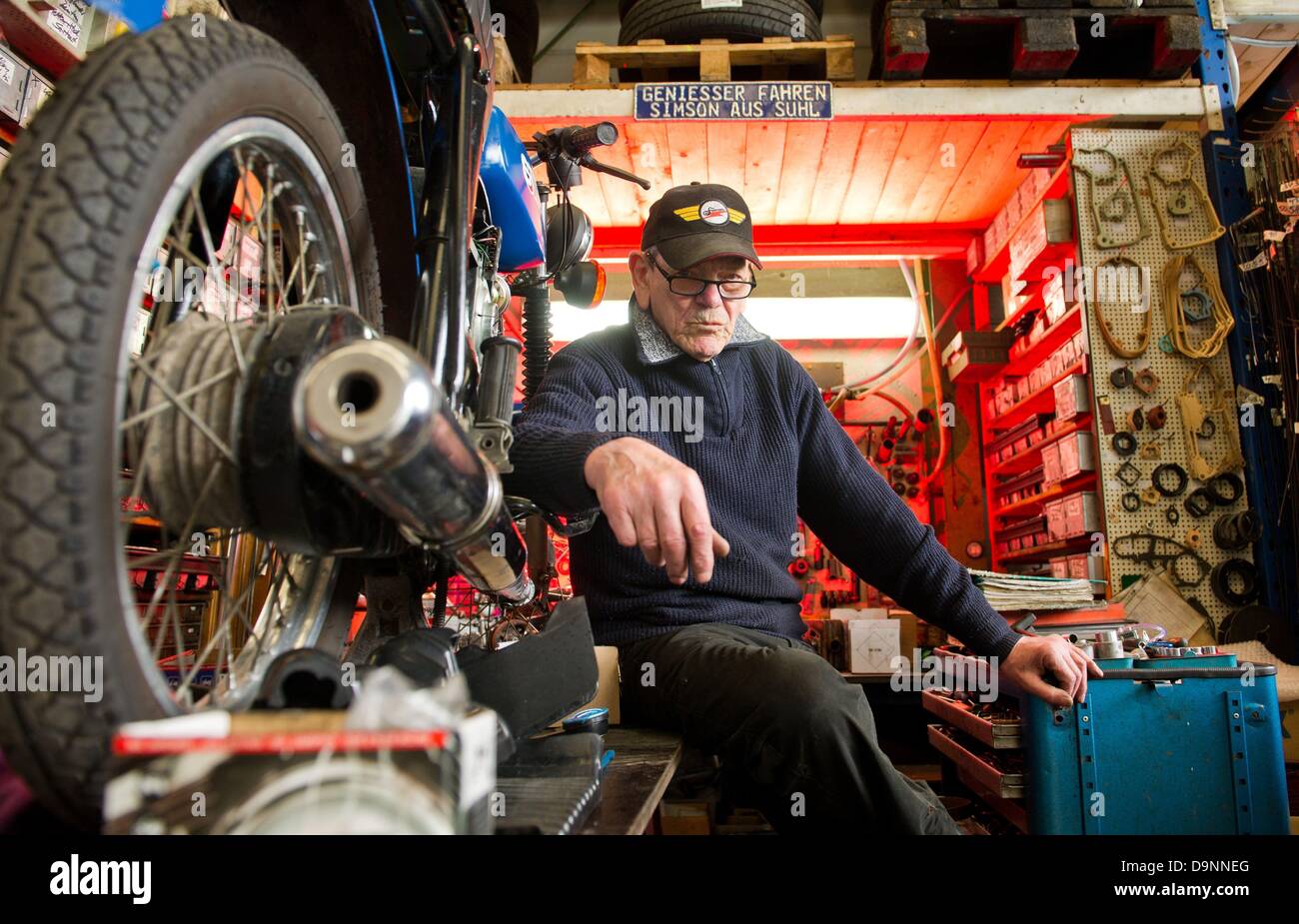 Juergen Heuer works at a Simson Motorcycle in his workshop in Hanover ...