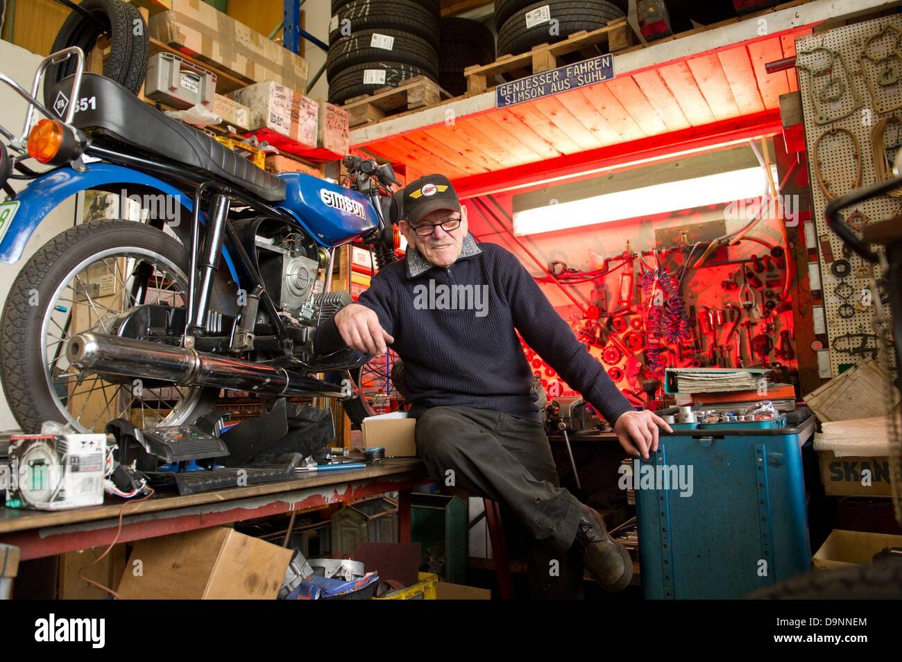 Juergen Heuer works at a Simson Motorcycle in his workshop in Hanover ...