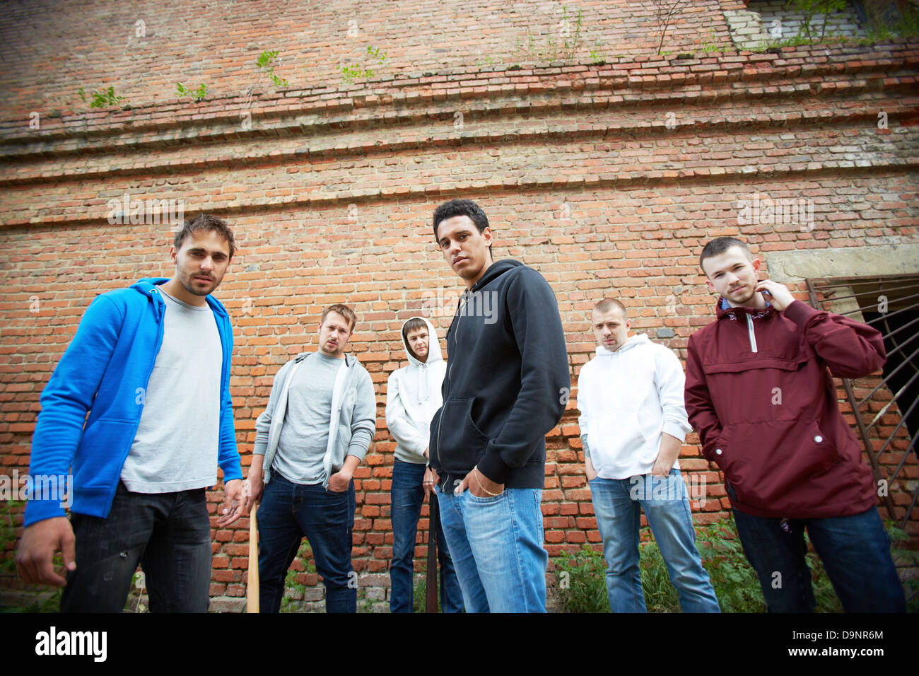 Group of street hooligans or rappers on background of brick wall Stock ...