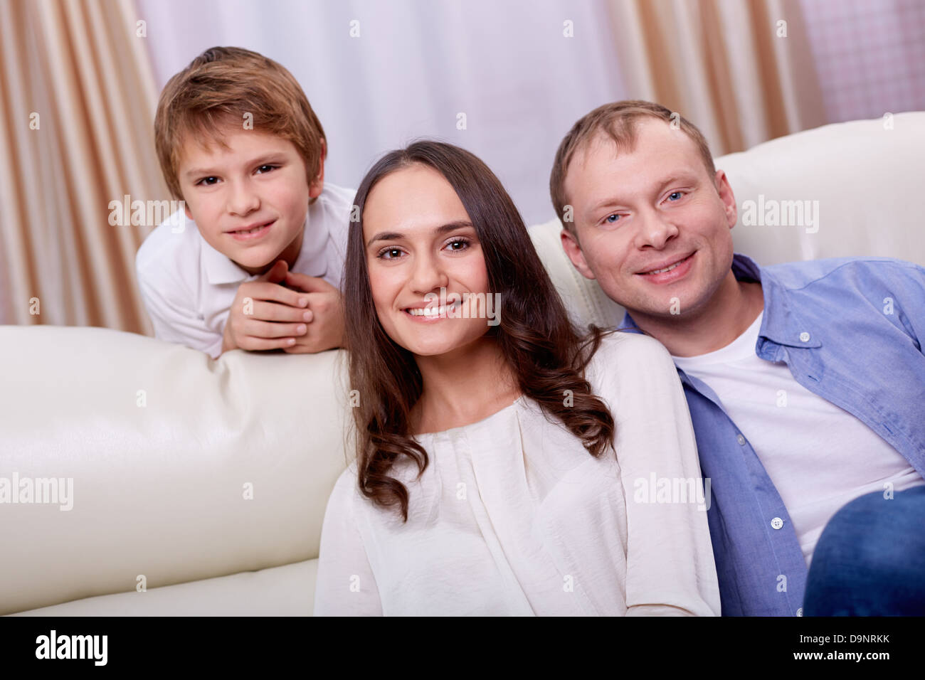 Portrait of happy family looking at camera at home Stock Photo - Alamy
