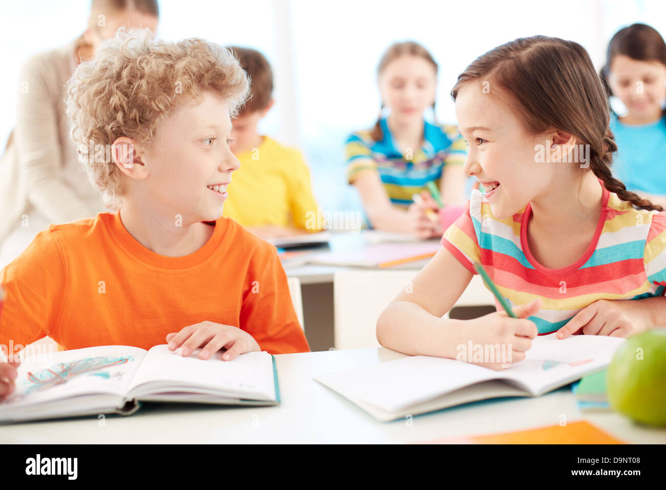 Portrait of two diligent pupils interacting while drawing at lesson ...
