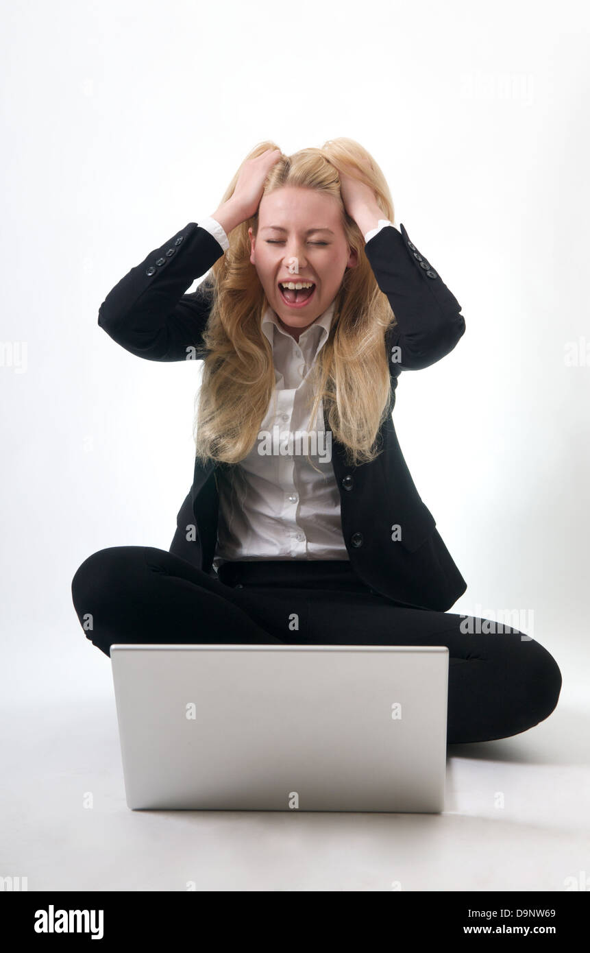 Computer frustration with angry girl Stock Photo - Alamy