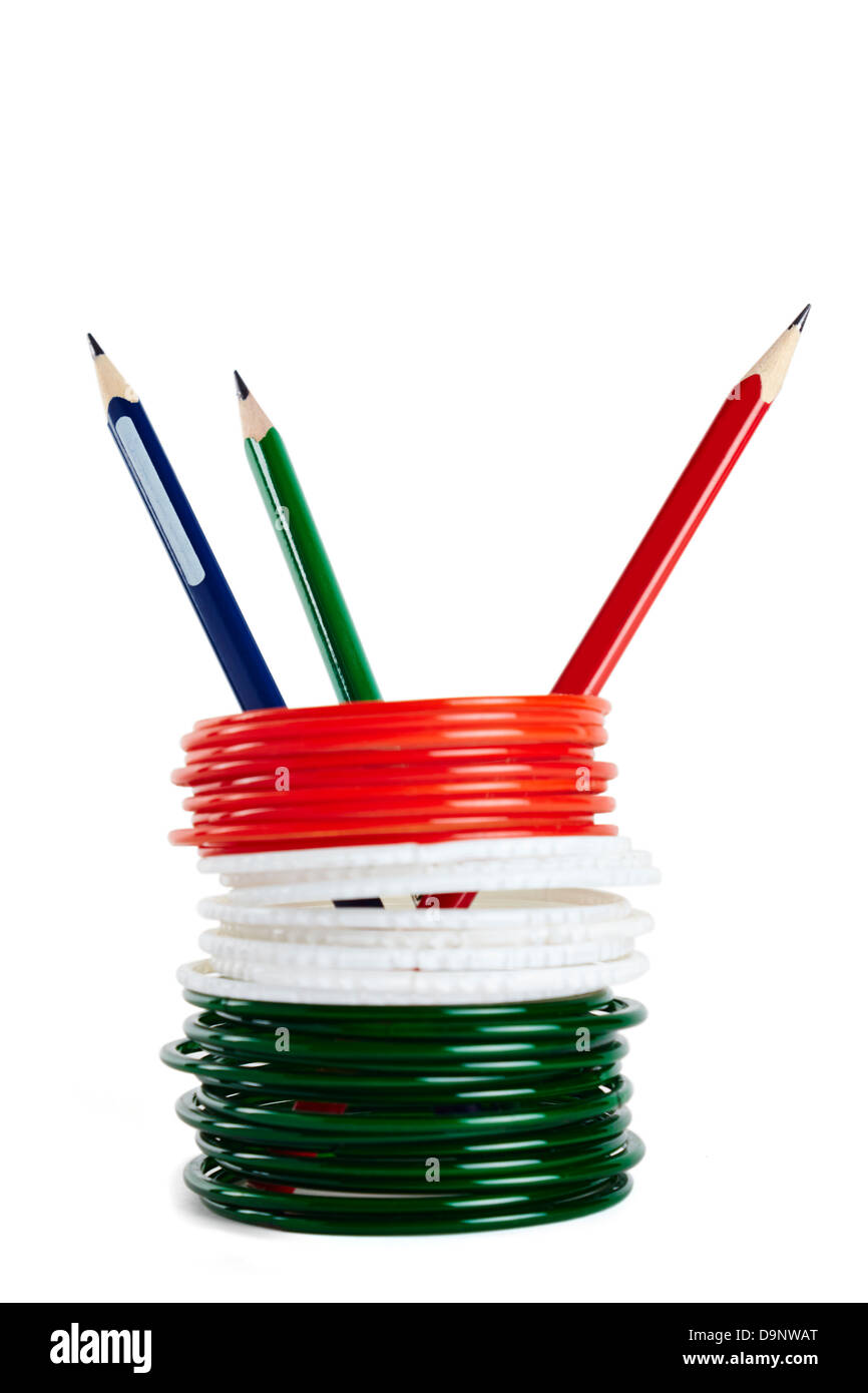 Pencils inside of a stand of bangles arranged in tri colours Stock ...