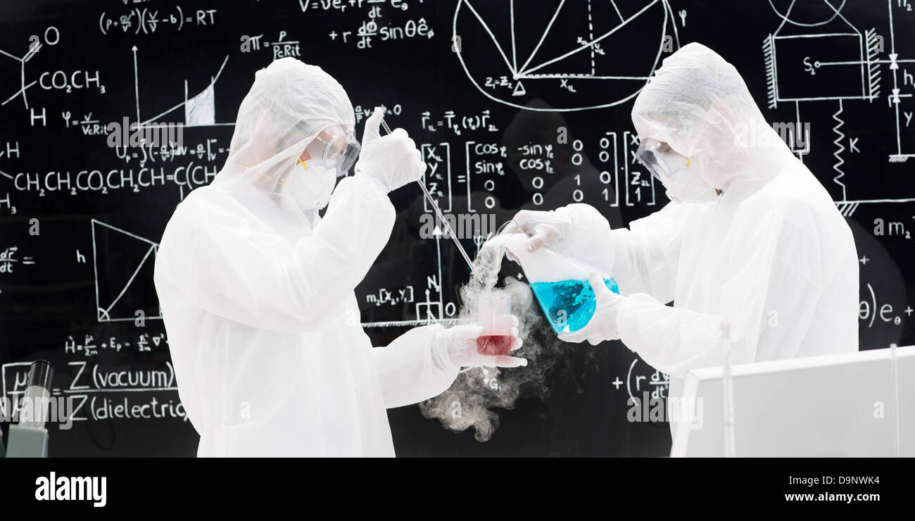 side-view of two peopleconducting a laboratory experiment with colorful ...