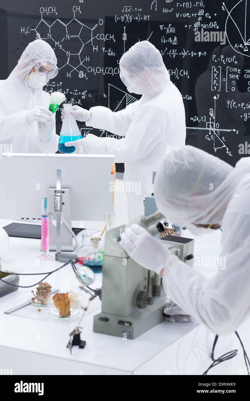 close-up of two scientists in a chemistry lab conducting an experiment ...