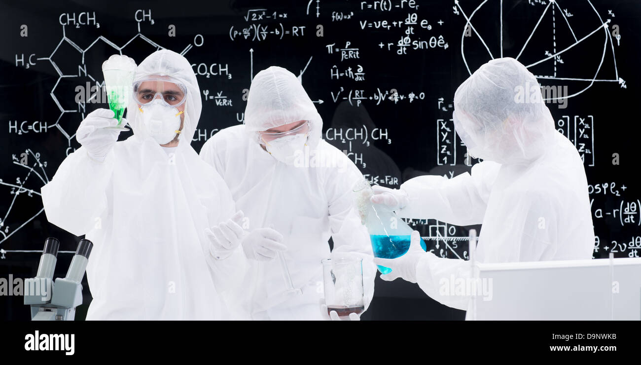 close-up of three people conducting a laboratory experiment using ...