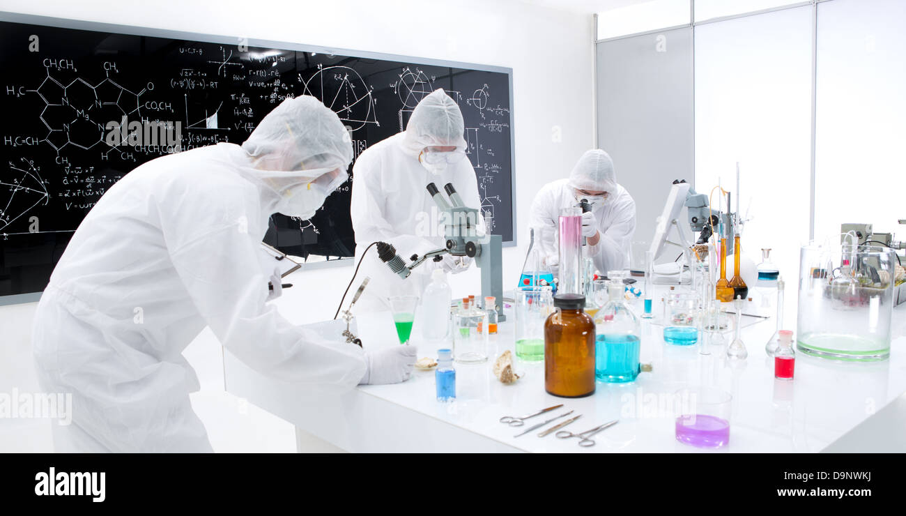 close-up of three people conducting a laboratory experiment using ...