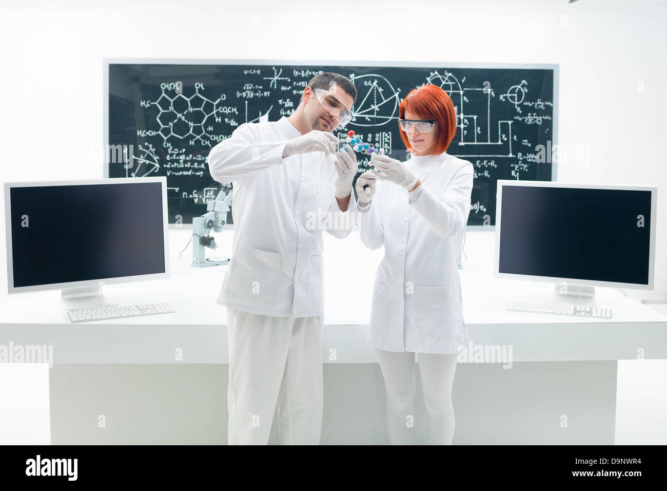 general-view of two people analyzing molecules in a chemistry lab with ...
