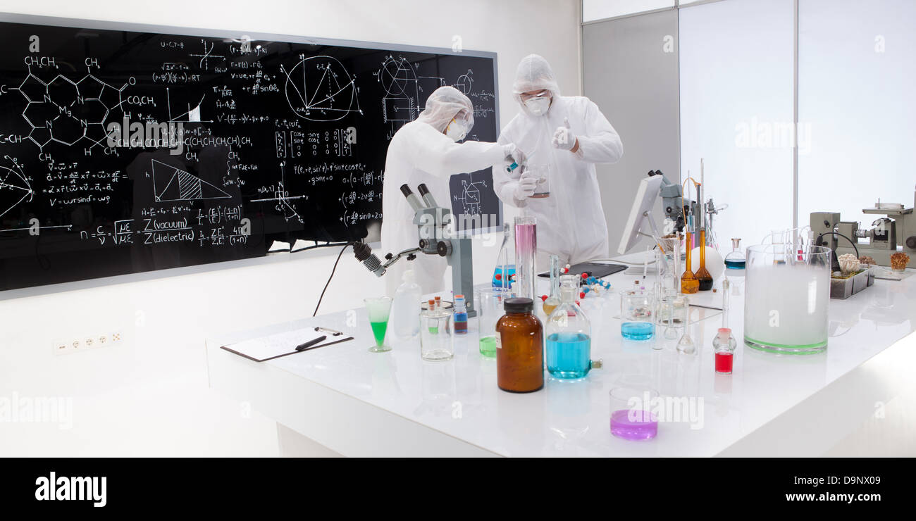 general view of two people making a laboratory experiment around a ...