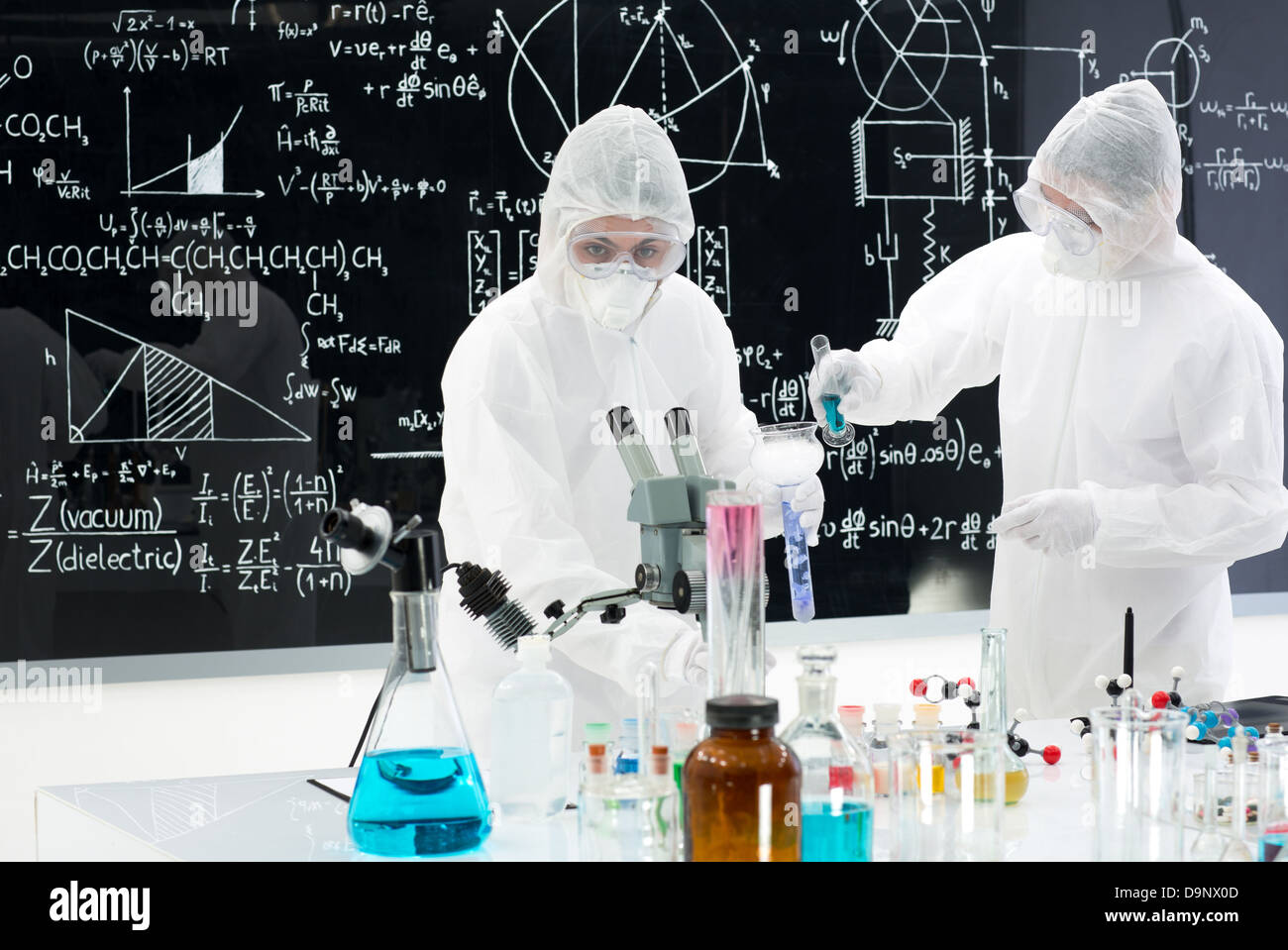 general view of two people making a laboratory experiment around a ...