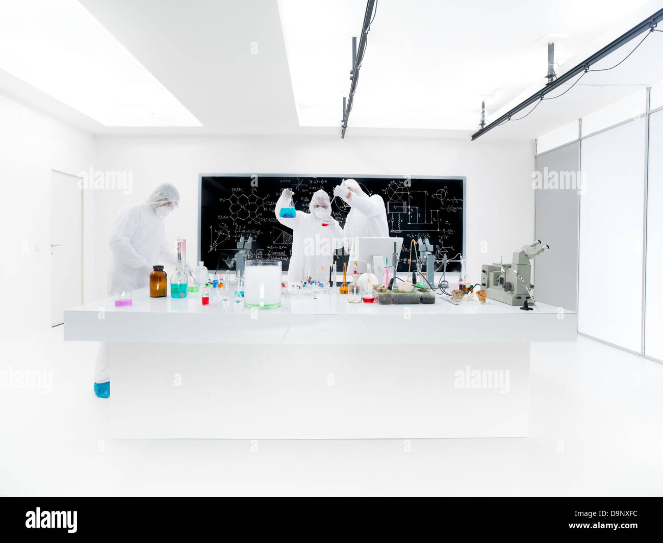 general-view of three scientists in a chemistry lab conducting an ...
