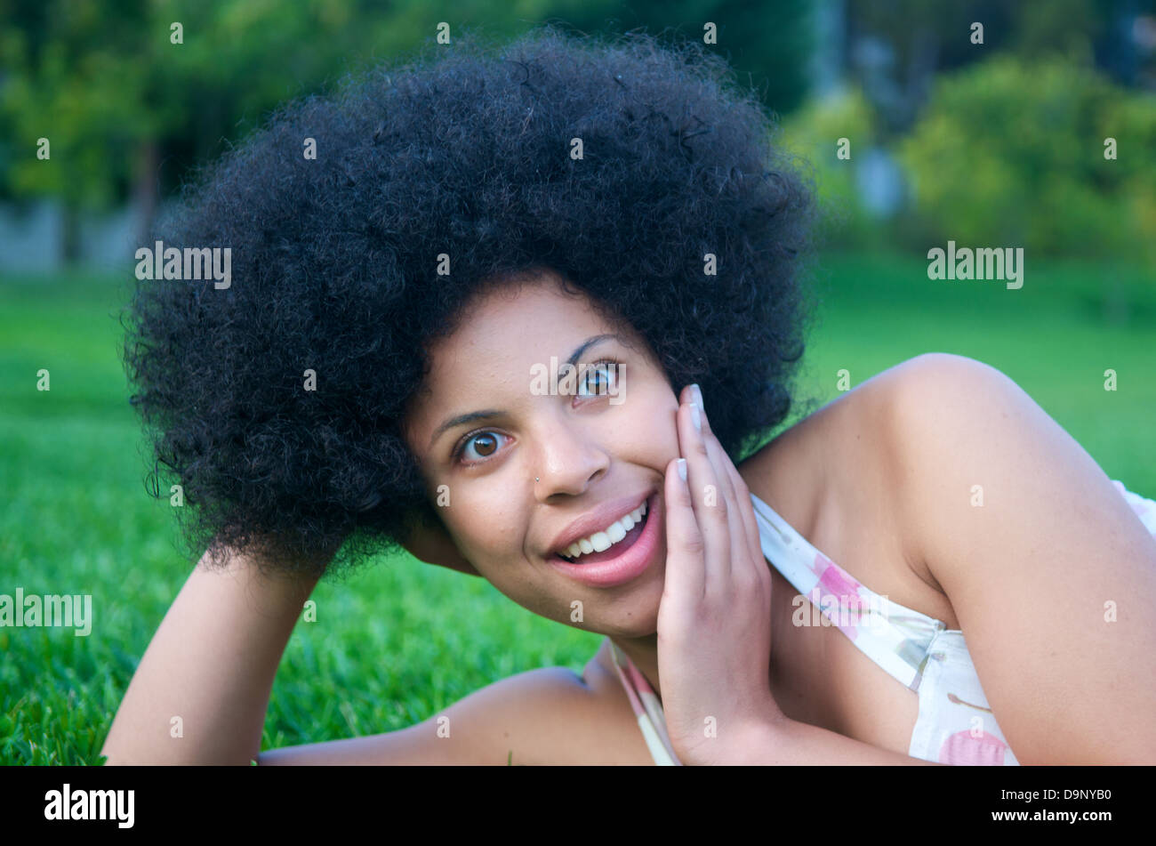 Portrait of beautiful african american model with afro look in nature ...