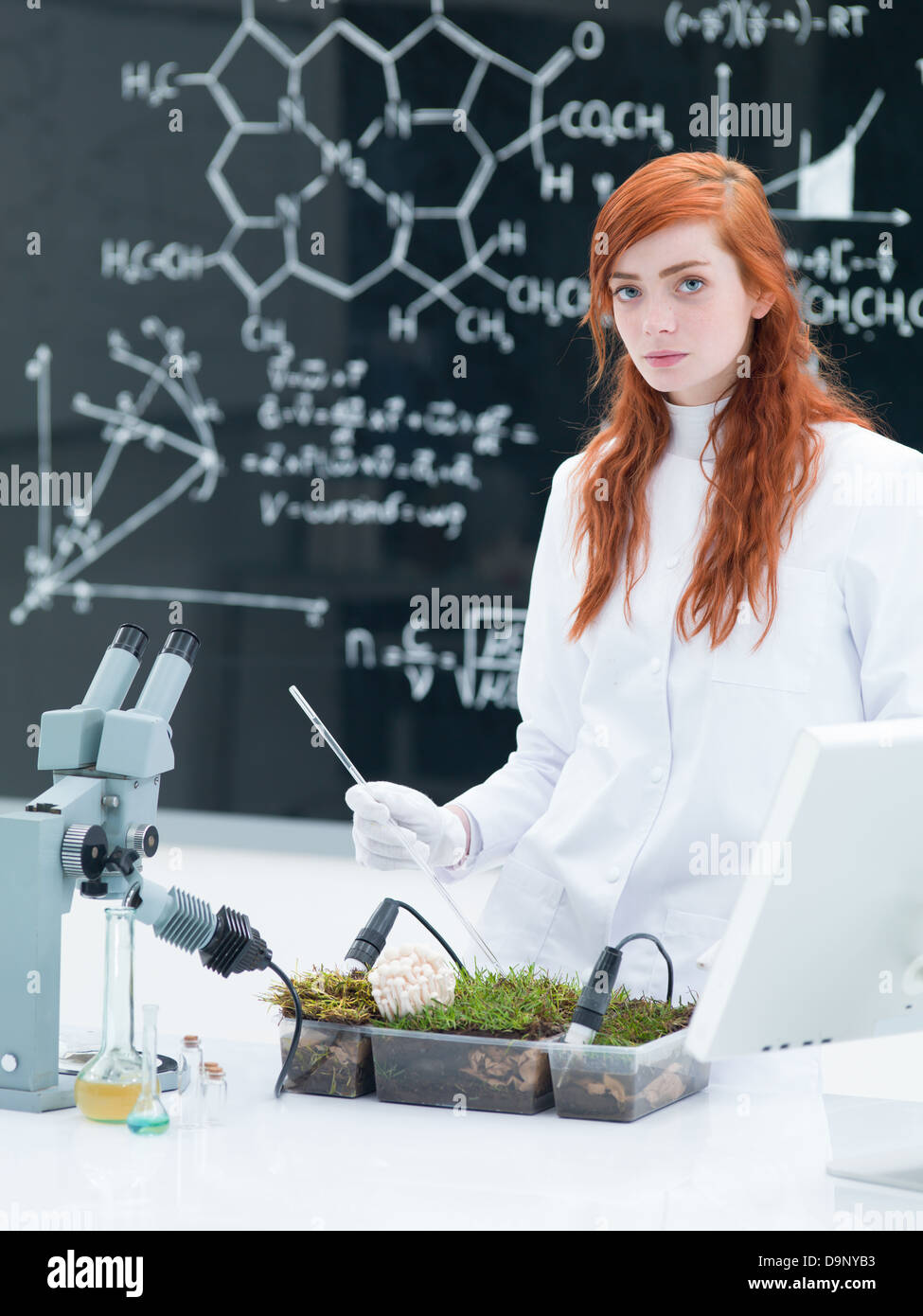general-view of a student in a chemistry lab conducting a grass ...
