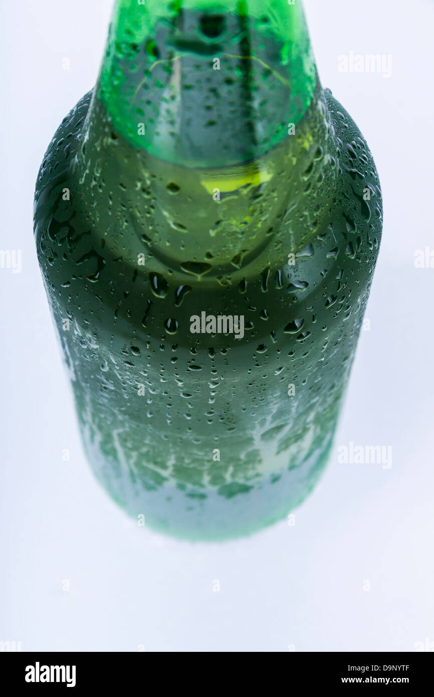 Wet bottle with cold beer on white background Stock Photo - Alamy
