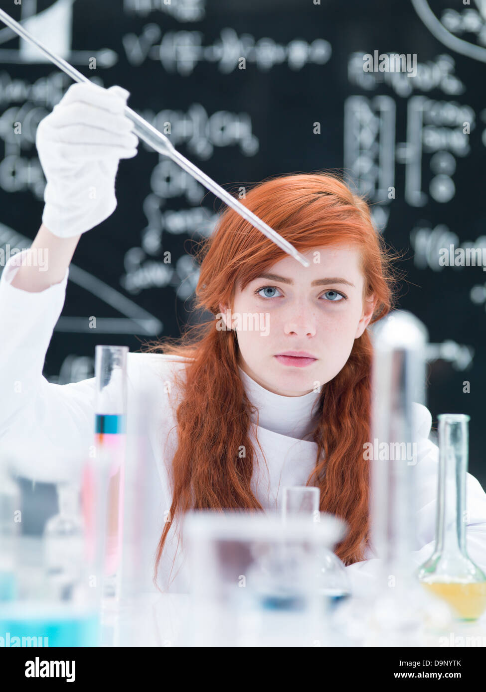 close-up of a student girl conducting a laboratory experiment on a lab ...