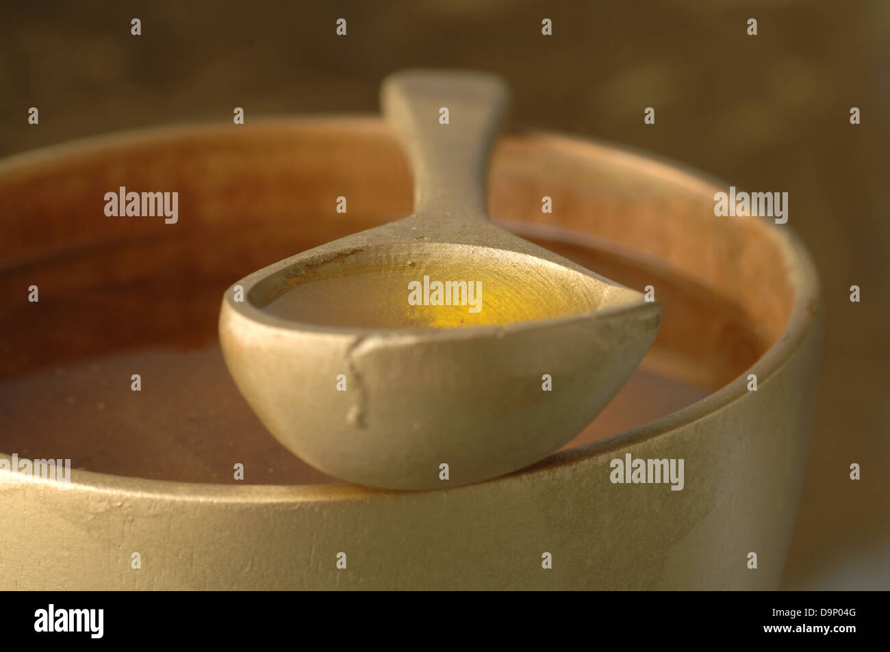 Ladle with oil Stock Photo - Alamy