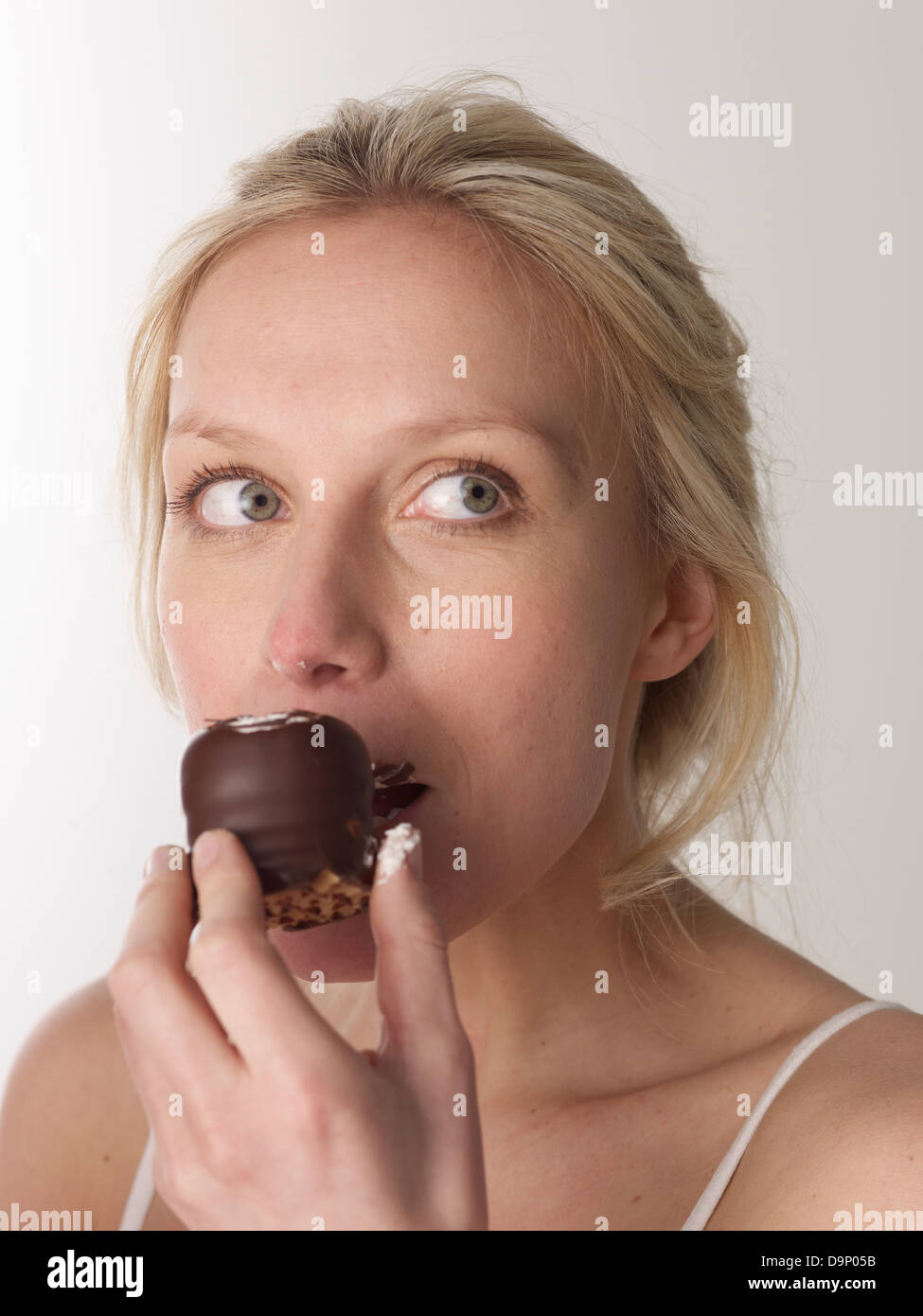 Woman eating chocolate marshmallow Stock Photo - Alamy