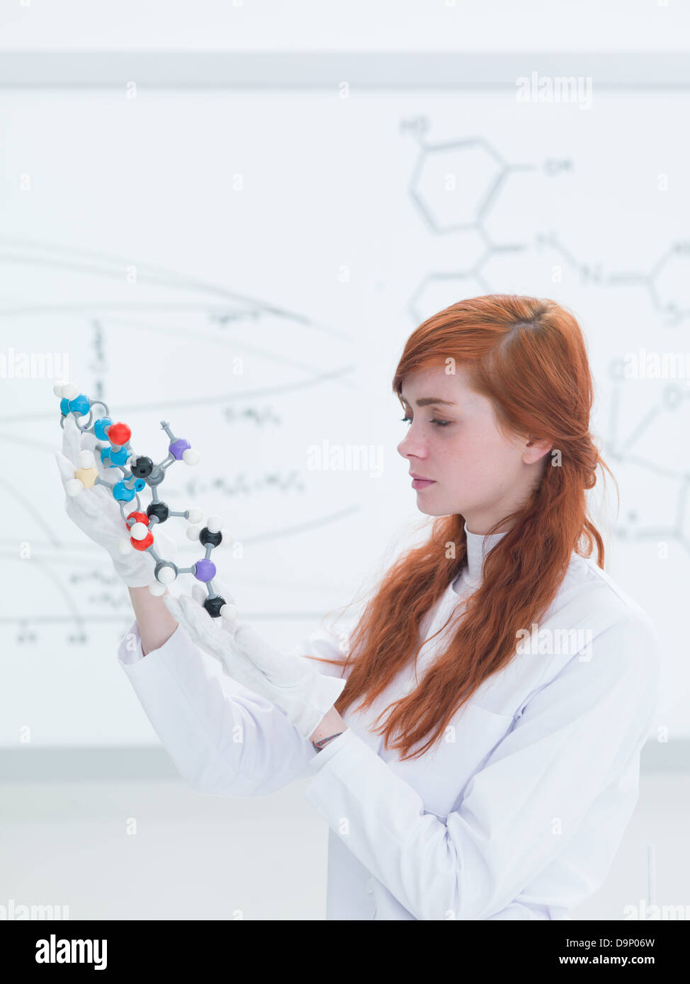 side-view of a beautiful girl student in a chemistry lab analyzing DMT ...