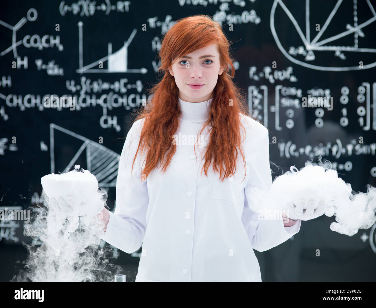 general-view of a pretty girl student in a chemistry lab conducting a ...