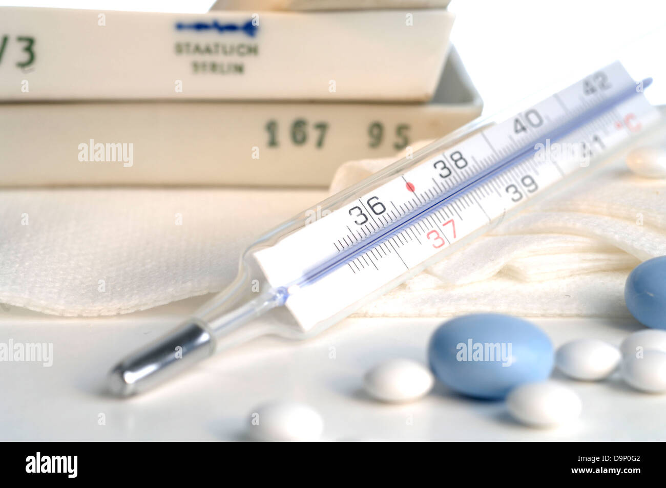 Pills and clinical thermometer Stock Photo - Alamy