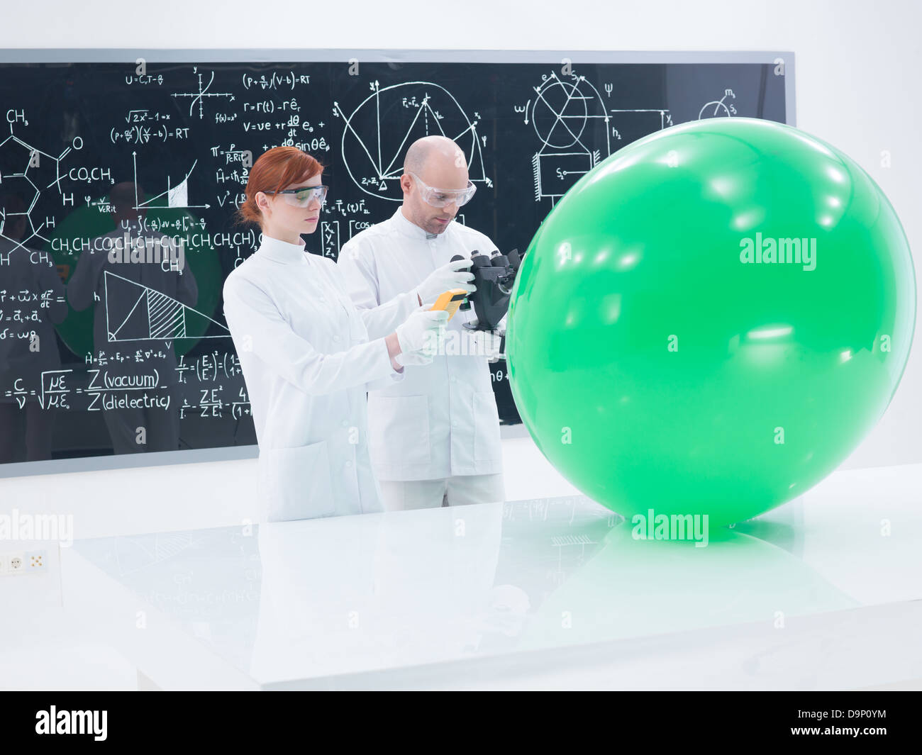 general-view of teacher and student in a chemistry lab scanning a green ...