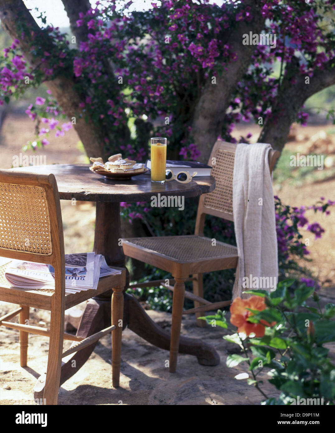 Mediterranean scene with bistro table and chairs Stock Photo - Alamy