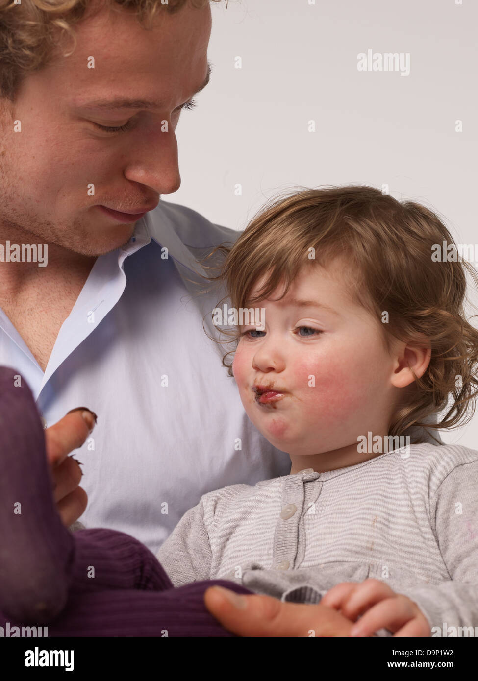 Father and daughter eating sweet things Stock Photo - Alamy