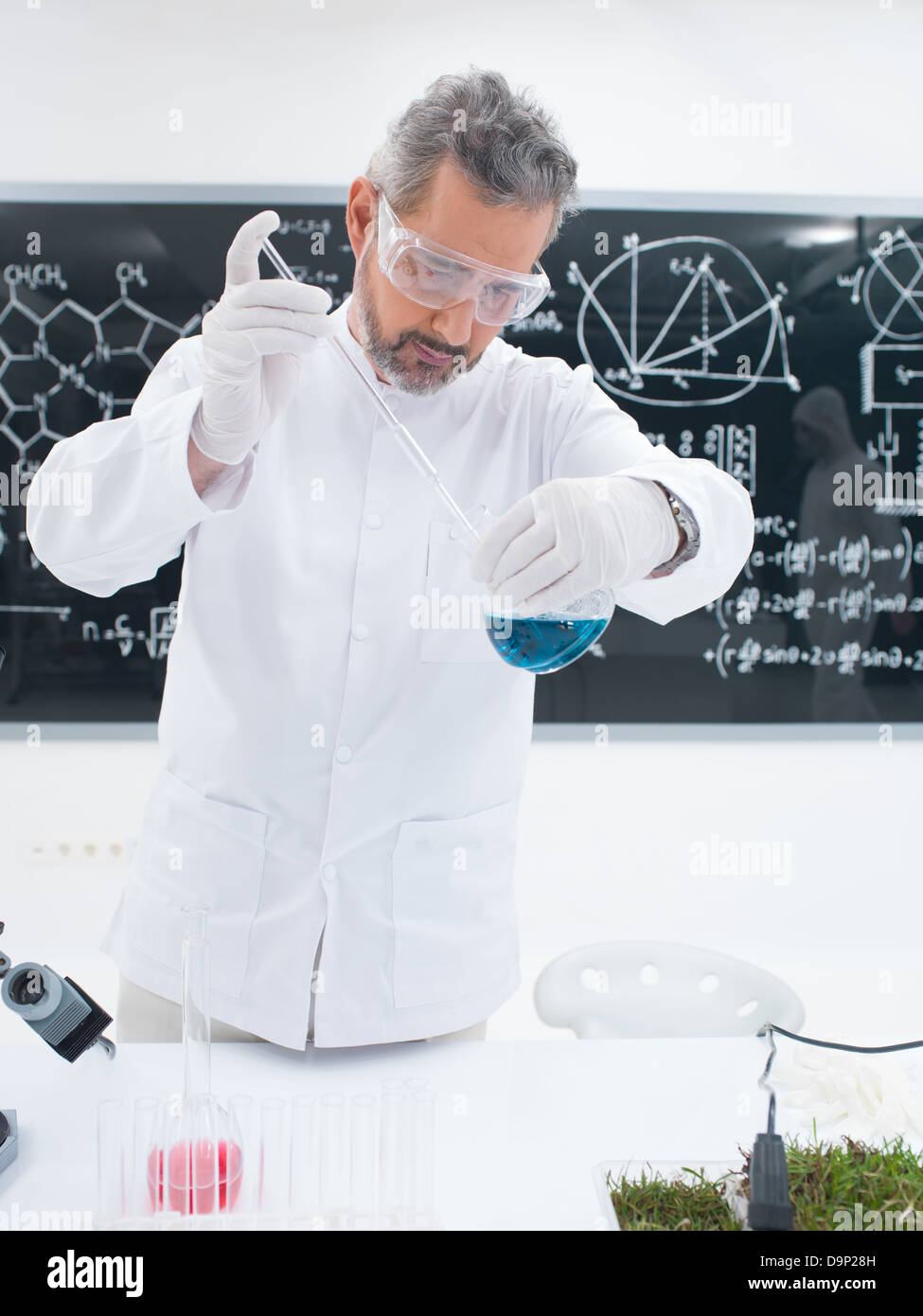 close-up of a scientist in a chemistry lab conducting an experiment ...