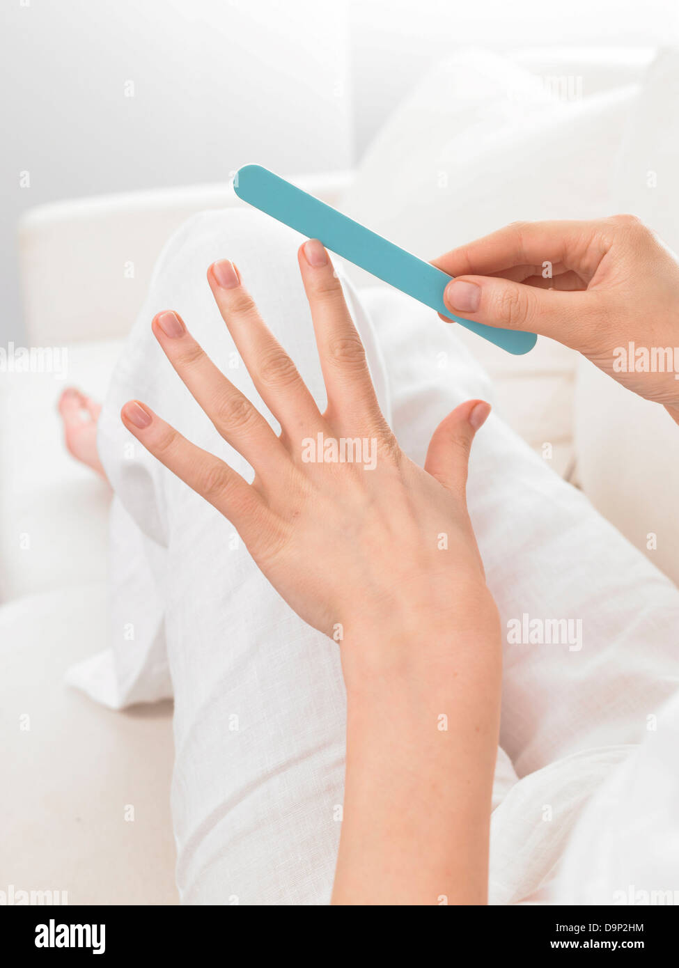 Woman filing her fingernails Stock Photo - Alamy