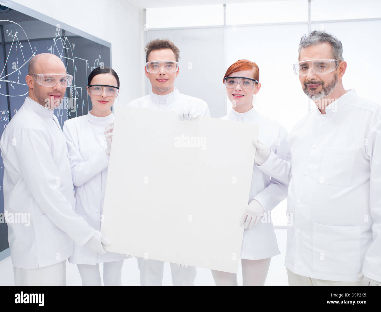 close-up of five scientists in a chemistry lab holding in hands an ...