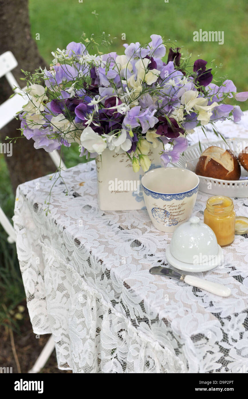 Flowers, honey and lye rolls on garden table Stock Photo - Alamy