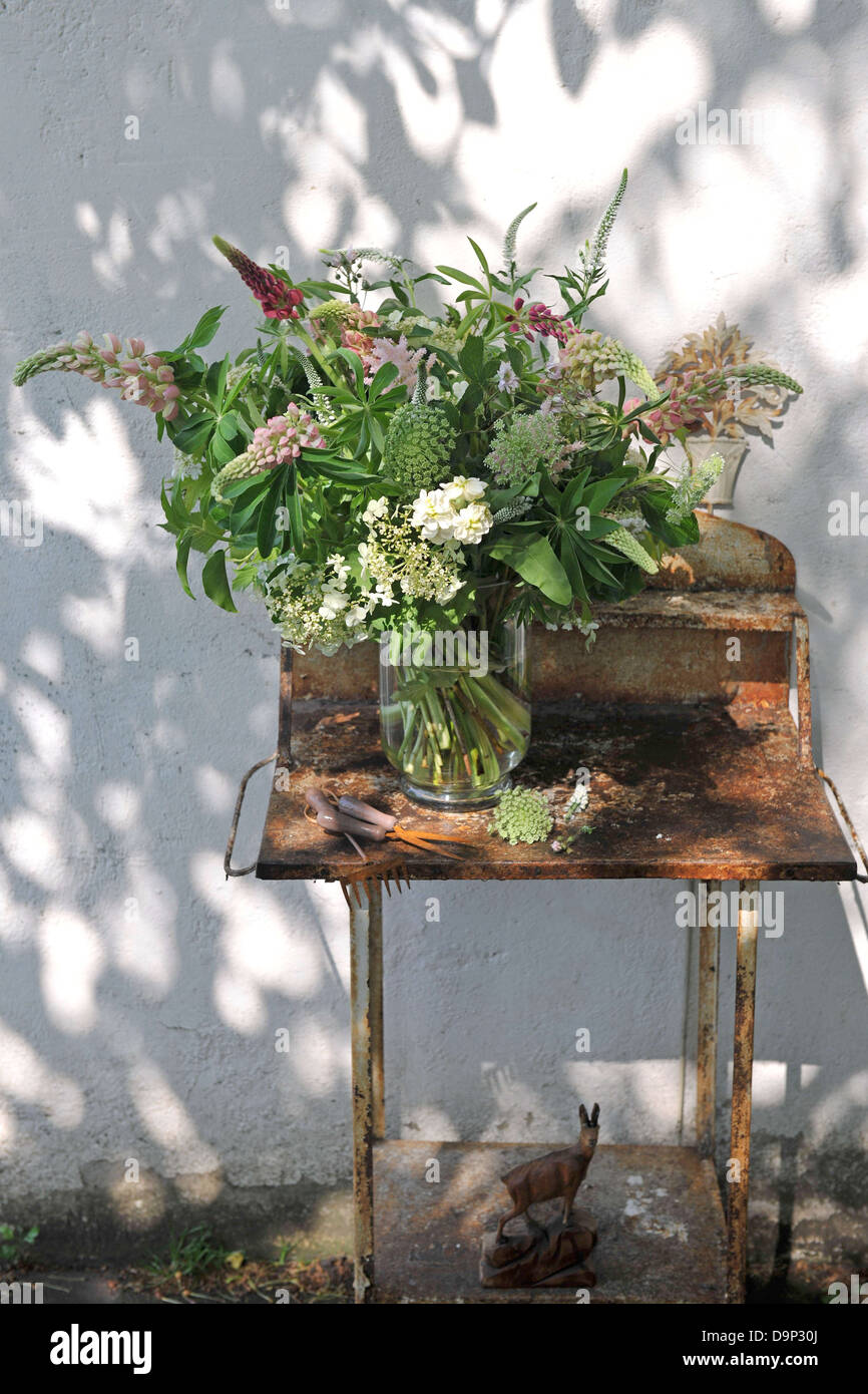 Bunch of flowers in vase outdoors Stock Photo - Alamy