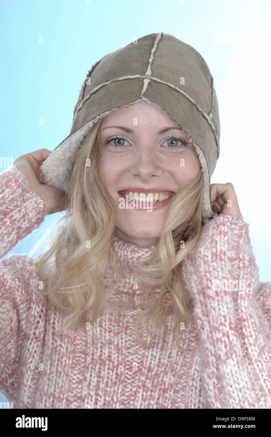 Woman wearing pullover and fur hat Stock Photo - Alamy