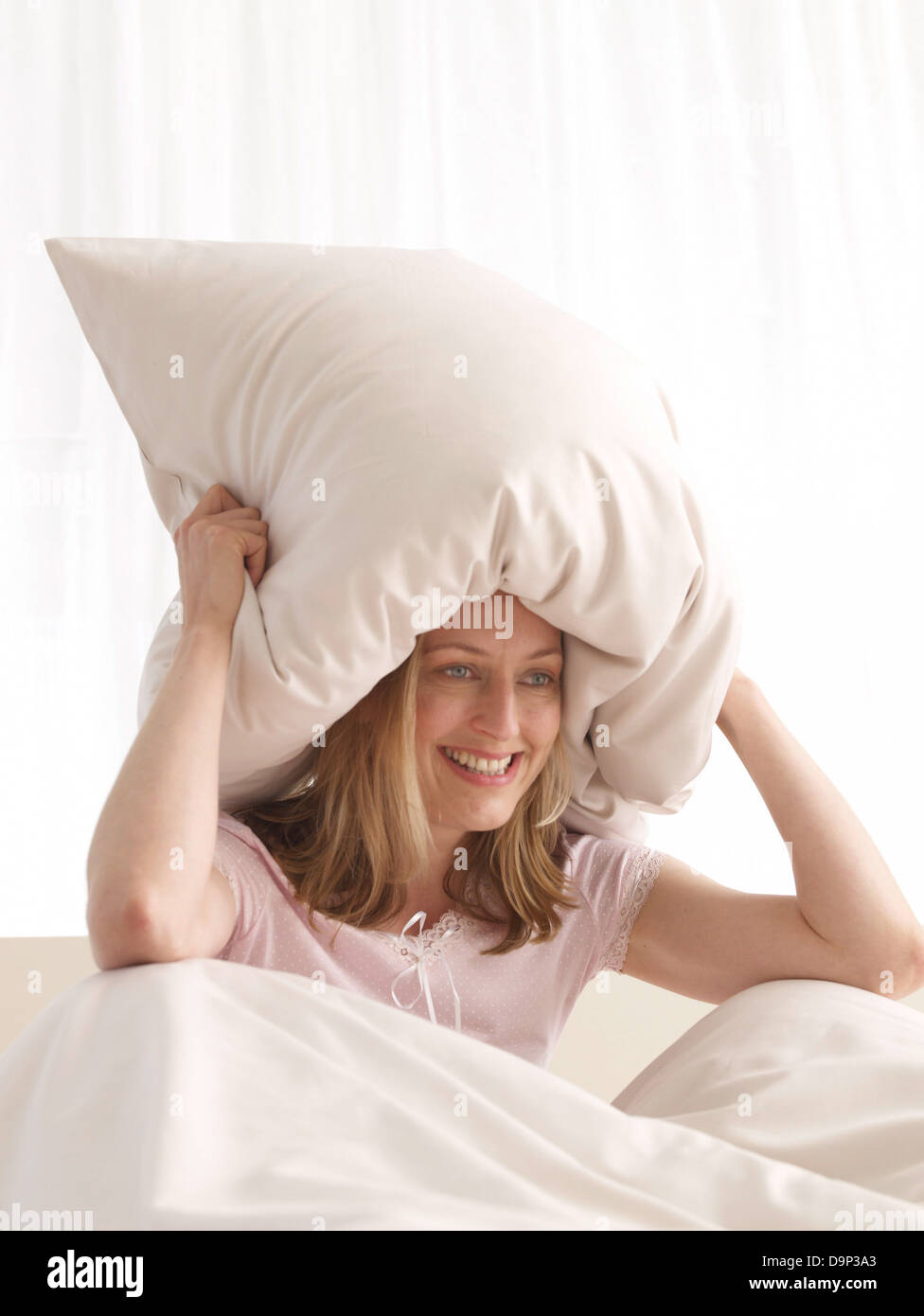 Happy woman in bed Stock Photo - Alamy