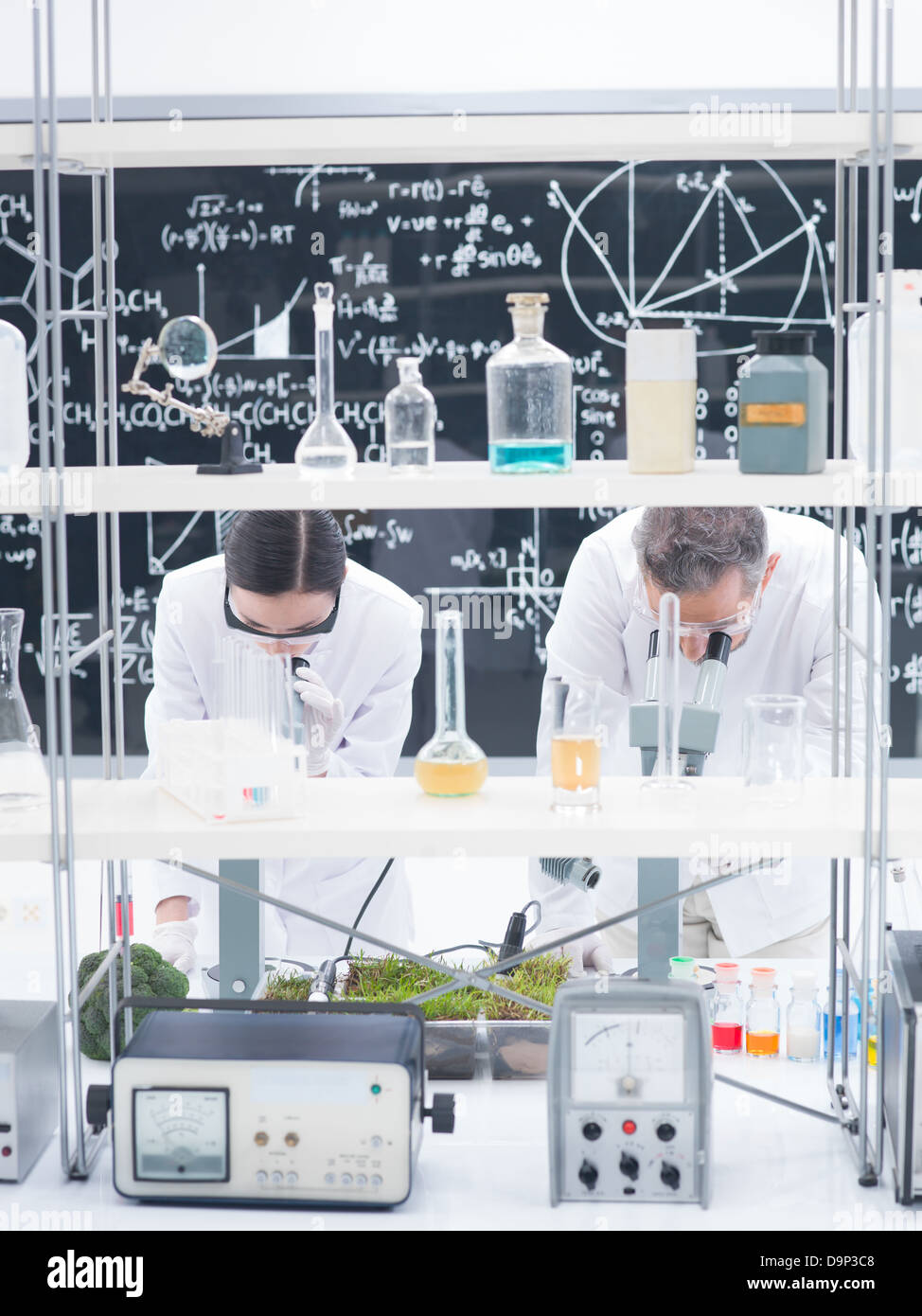 general-view of two researchers i a chemistry lab analyzing under ...